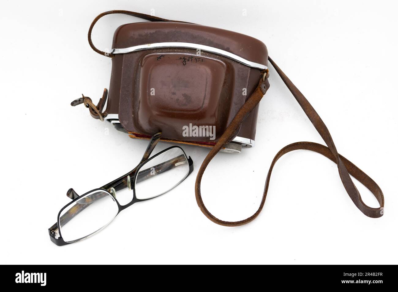 Vintage old retro camera in brown leather case with pair of glasses and ...