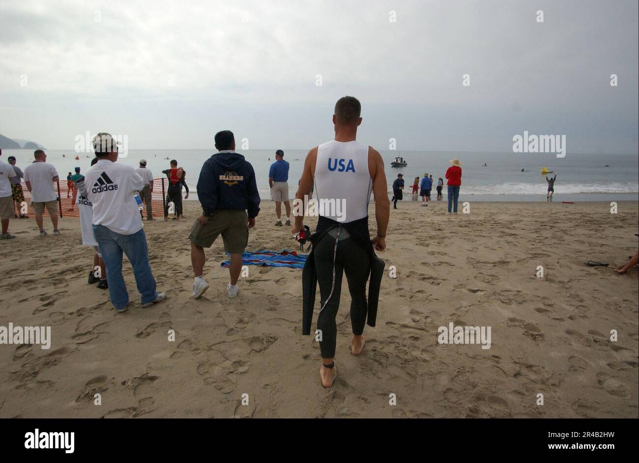 US Navy A Navy team member makes his way to the swim start at Naval ...