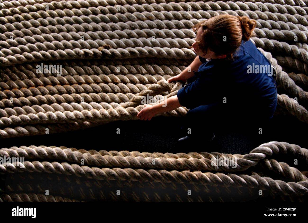 US Navy Seaman prepares mooring lines on the fantail during a sea and ...