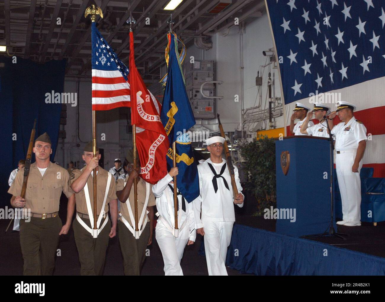 US Navy Officers salute as the colors are paraded during a change of command ceremony held in ...