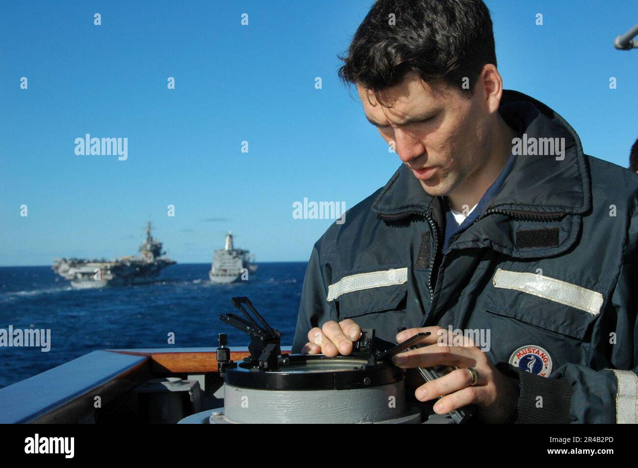 US Navy Quartermaster 2nd Class consults an azimuth circle aboard the ...