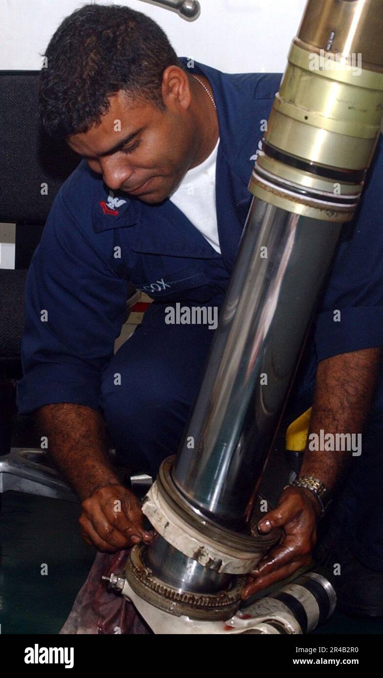 US Navy Aviation Structural Mechanic prepares a nose strut of an F-A ...