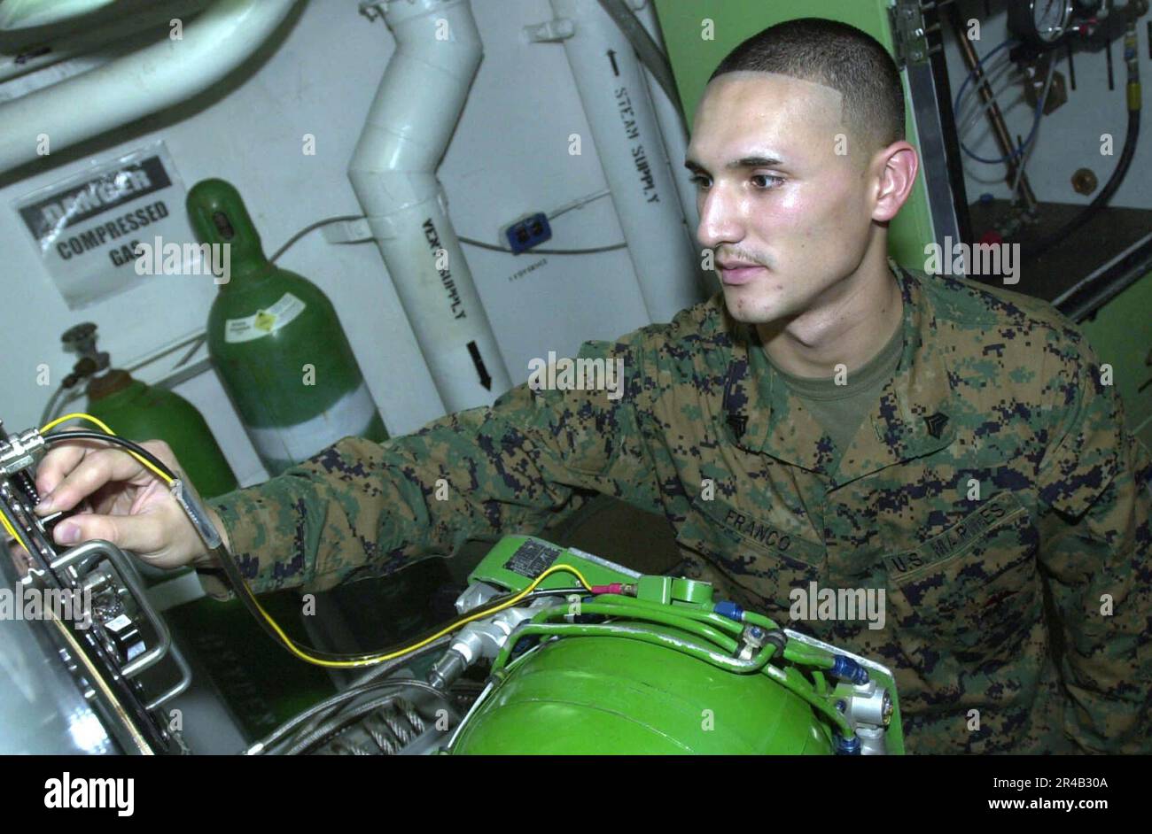 US Navy U.S. Marine Corps Sgt. tests and checks an aircraft oxygen tank ...