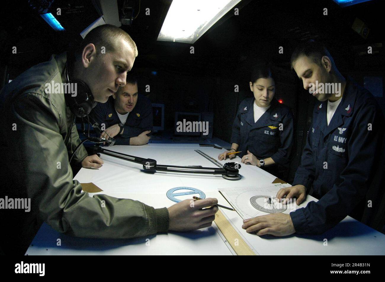US Navy Aviation Warfare Systems Operators practice technical plotting ...