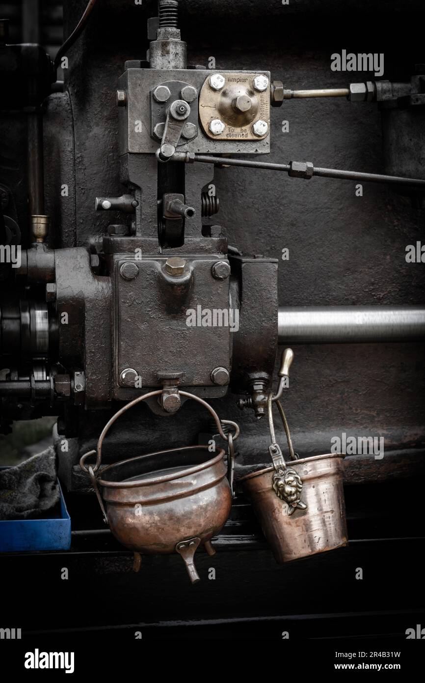 A robotic arm equipped with a bucket holding a variety of objects Stock ...