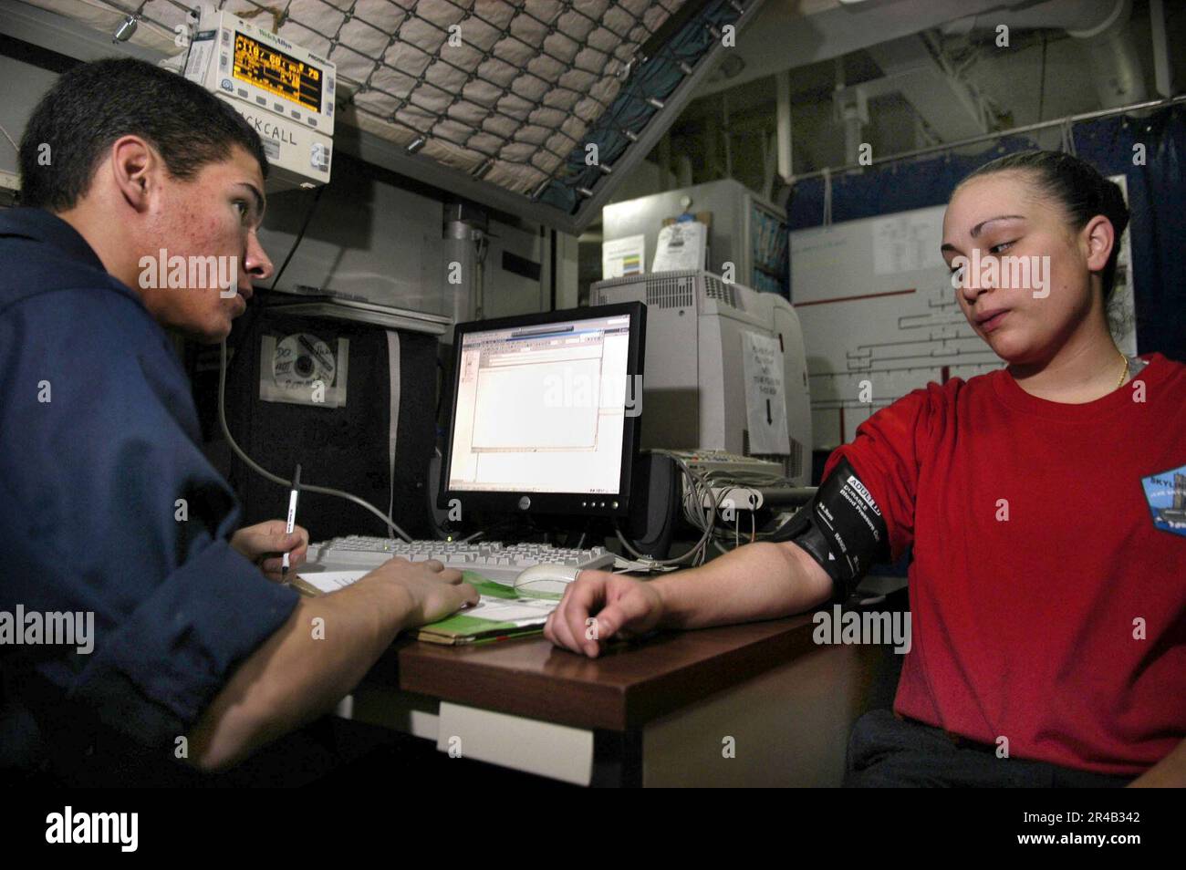 US Navy Hospitalman Apprentice monitors a Sailor's vital signs Stock ...