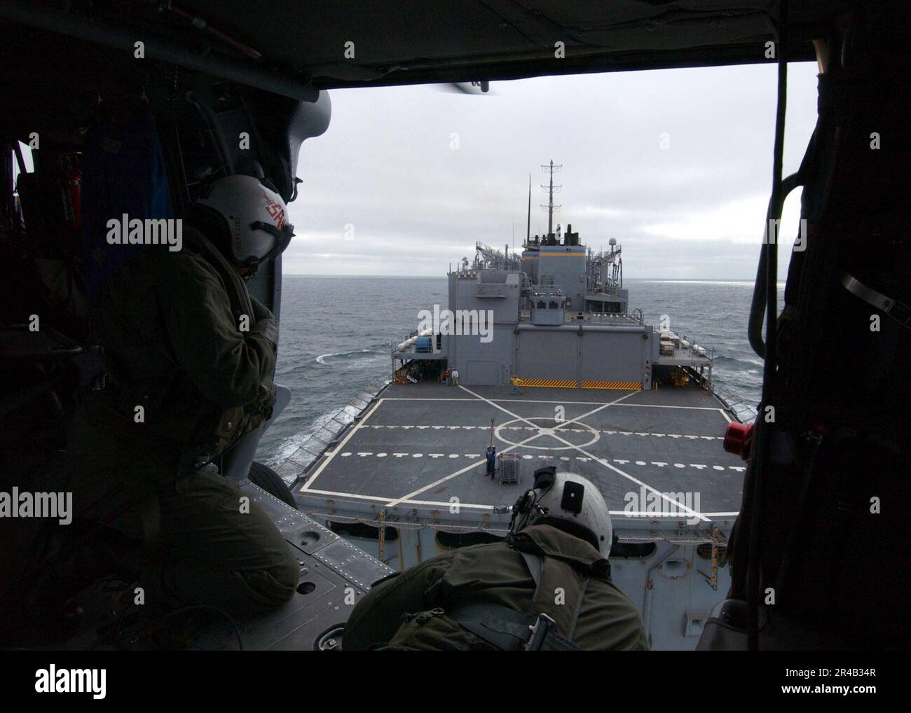 US Navy Air crewmen, assigned to Helicopter Sea Combat Squadron Three (HSC-3), keep a watchful ...