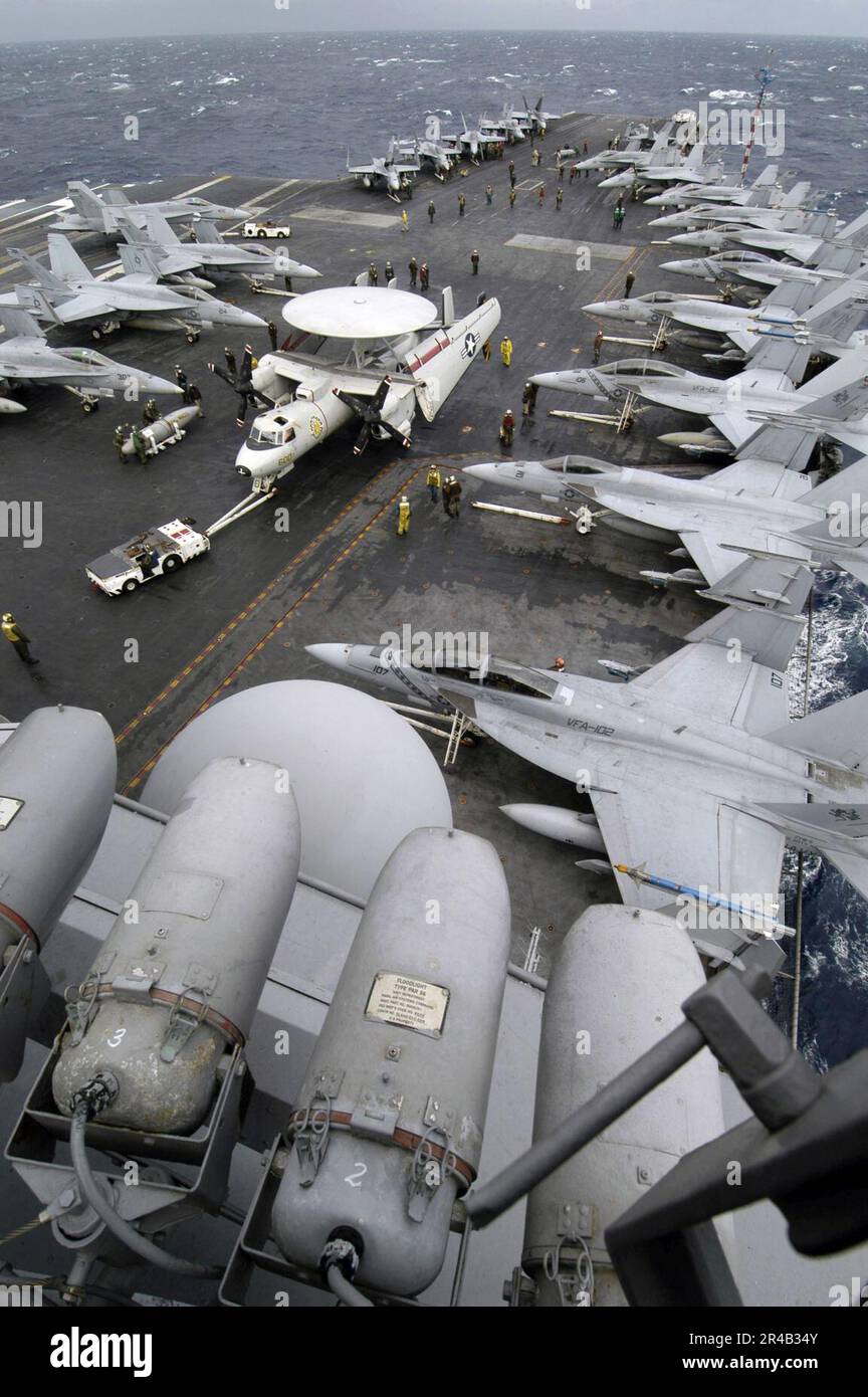 US Navy Air Department Sailors move an E-2C Hawkeye down the crowded ...