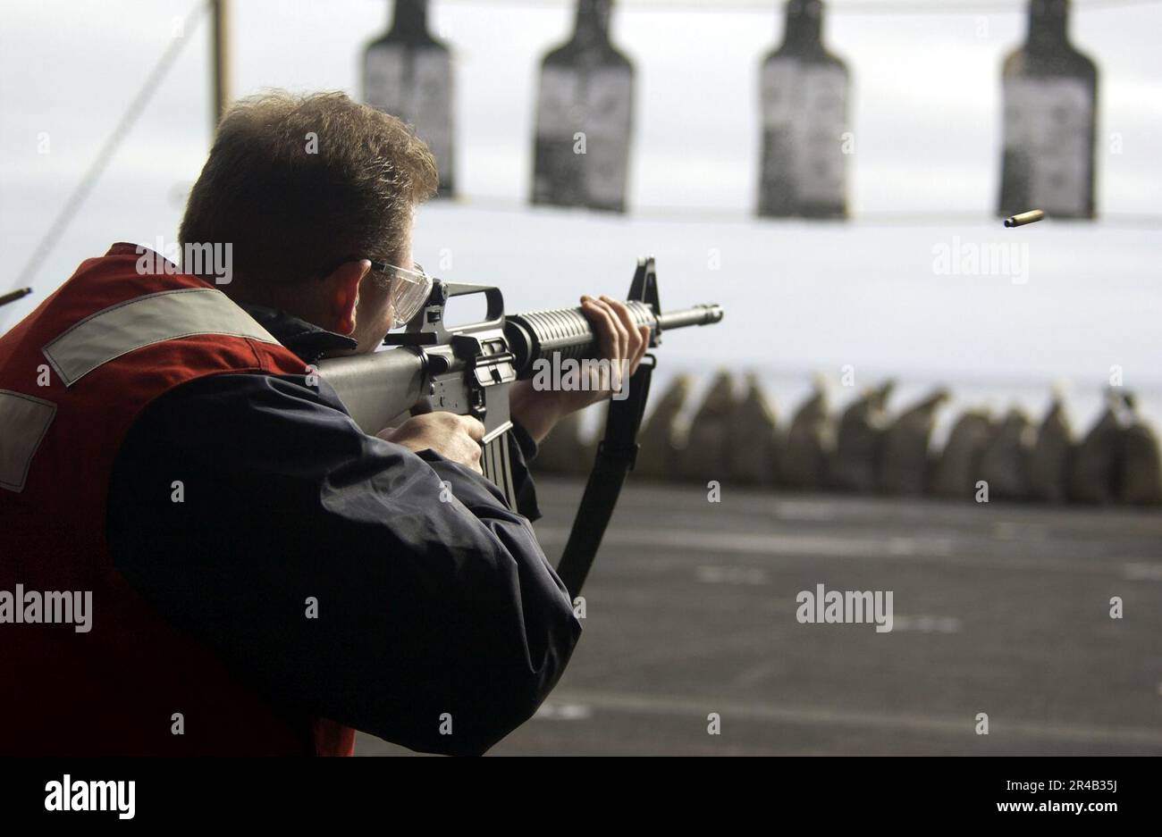 US Navy Lithographer 2nd Class fires an M-16 rifle during a live-fire ...