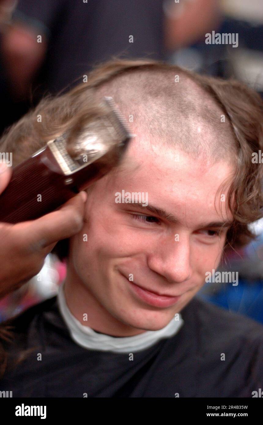 US Navy receives his first military haircut during Induction day at the ...