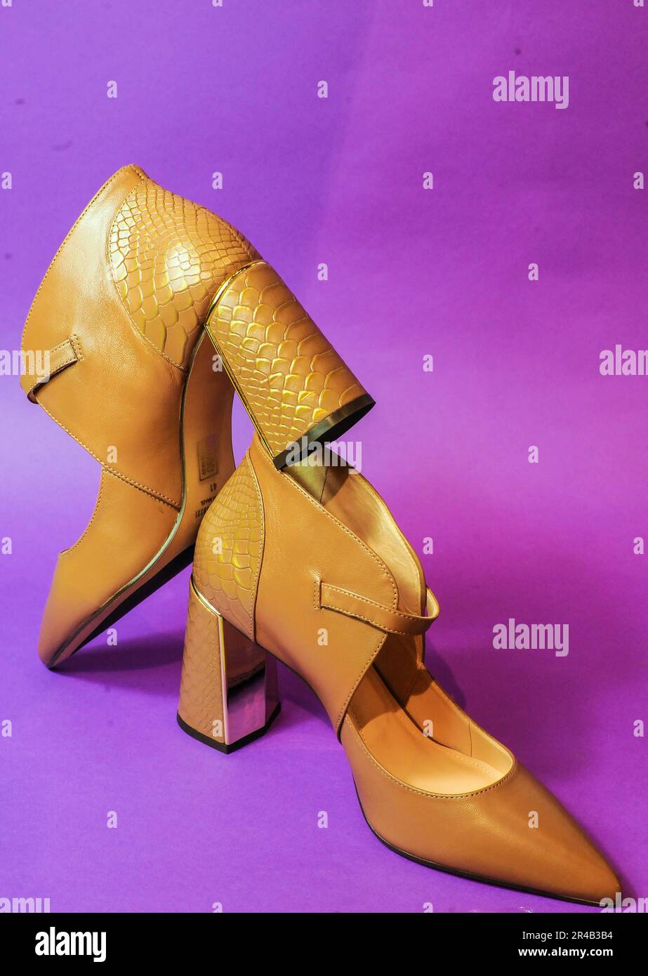 A contemporary pair of tan footwear featuring an open-toe design and ...