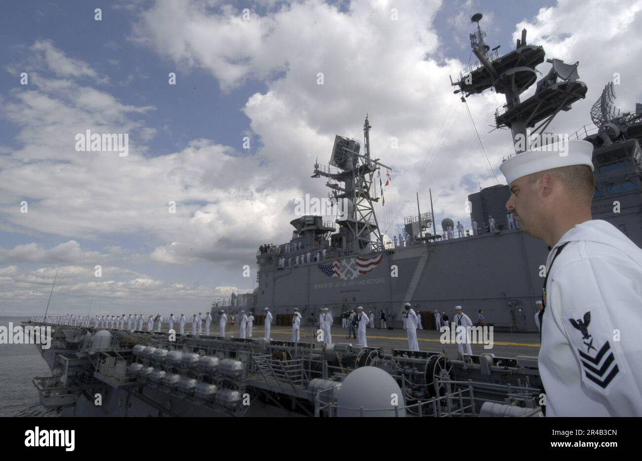 US Navy Sailors on the flight deck aboard the amphibious assault ship ...