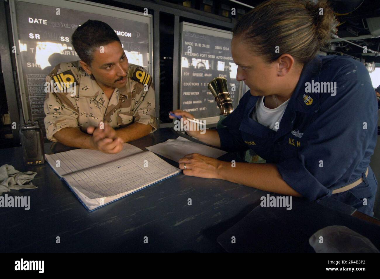 US Navy Senior Chief Quartermaster gives navigation training to an ...