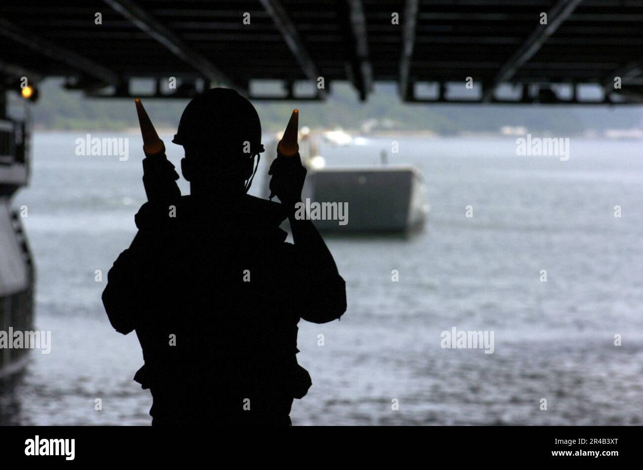 US Navy Seaman guides Landing Craft, Utility (LCU) 1631, assigned to ...