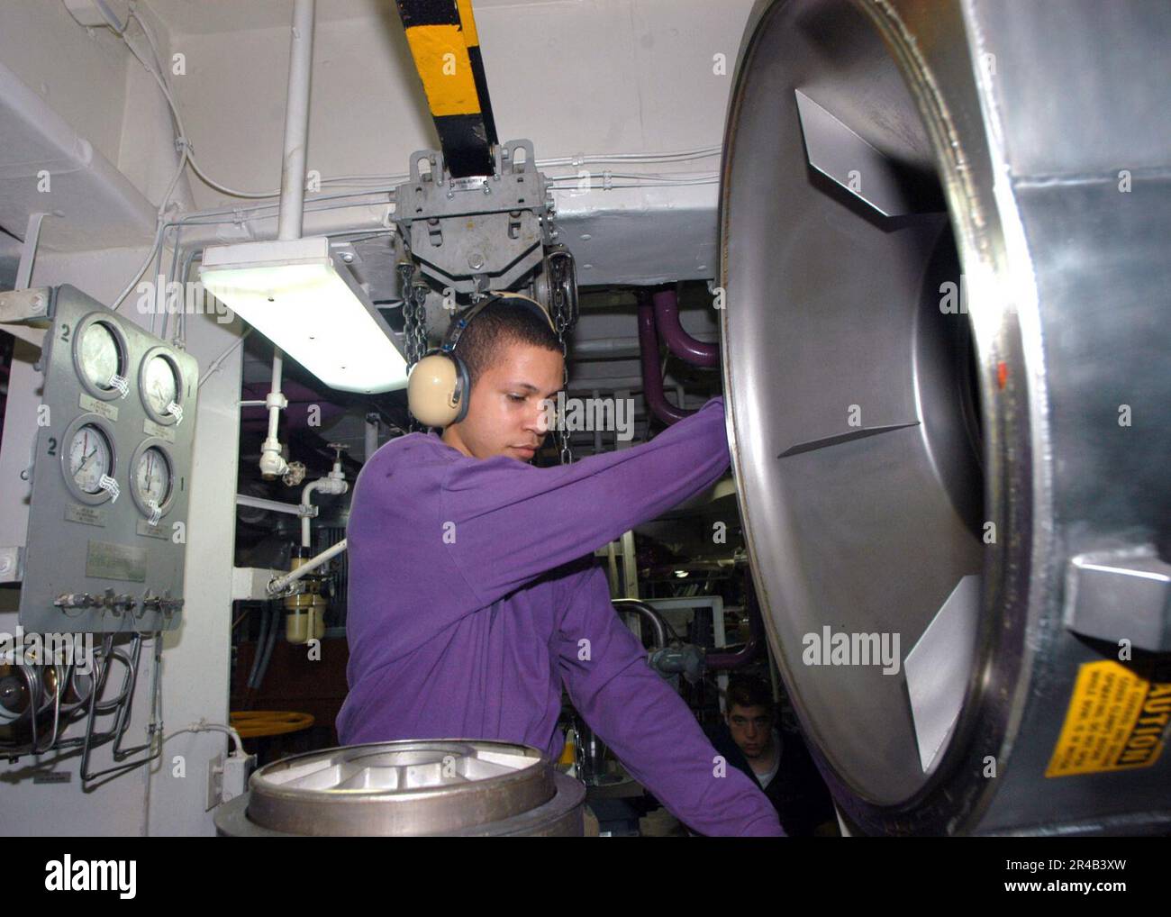 US Navy Airman opens a fuel purifier to ensure everything is in proper ...
