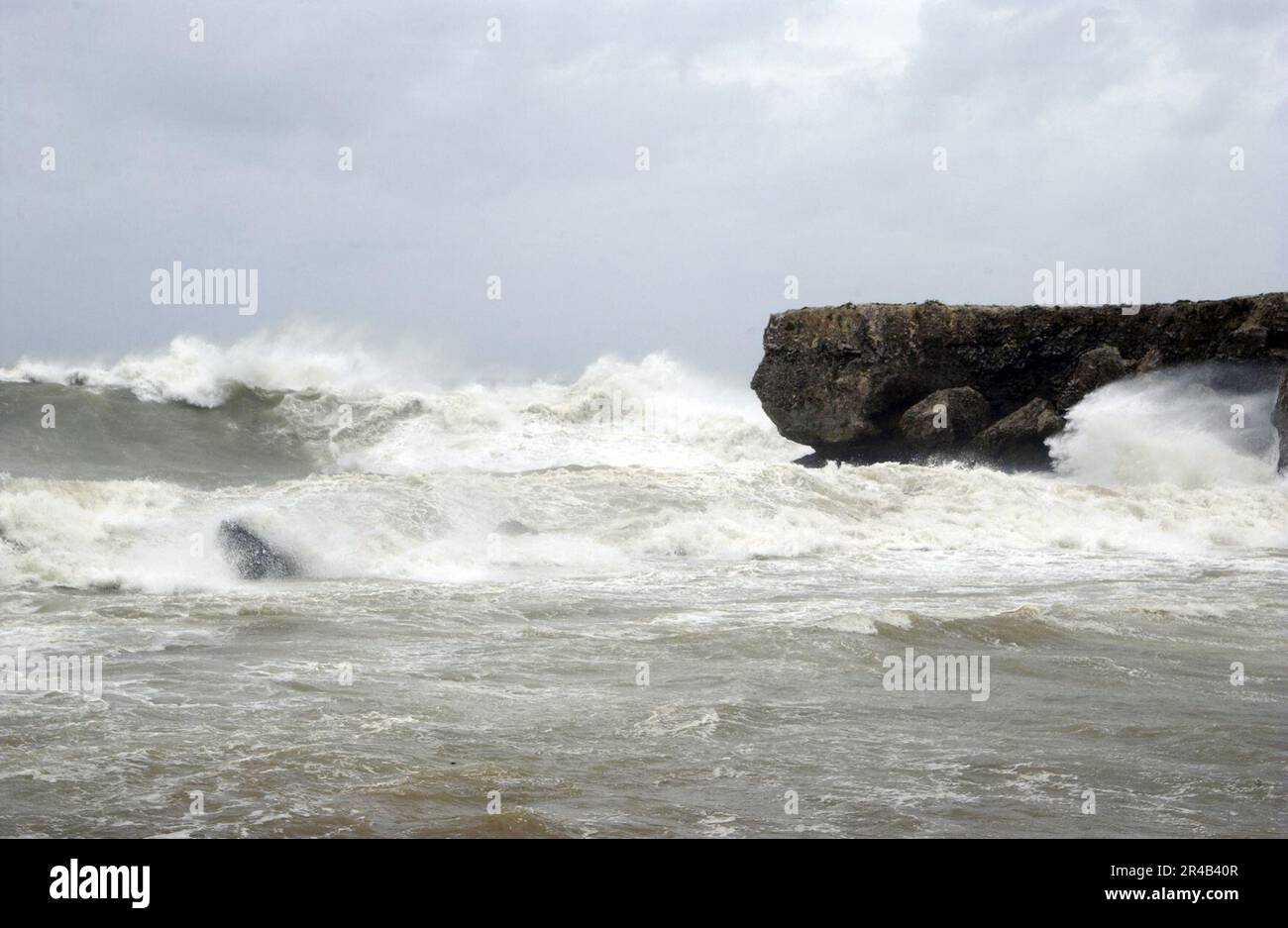 US Navy Waves crash against a 30-foot cliff at Cable Beach located on ...