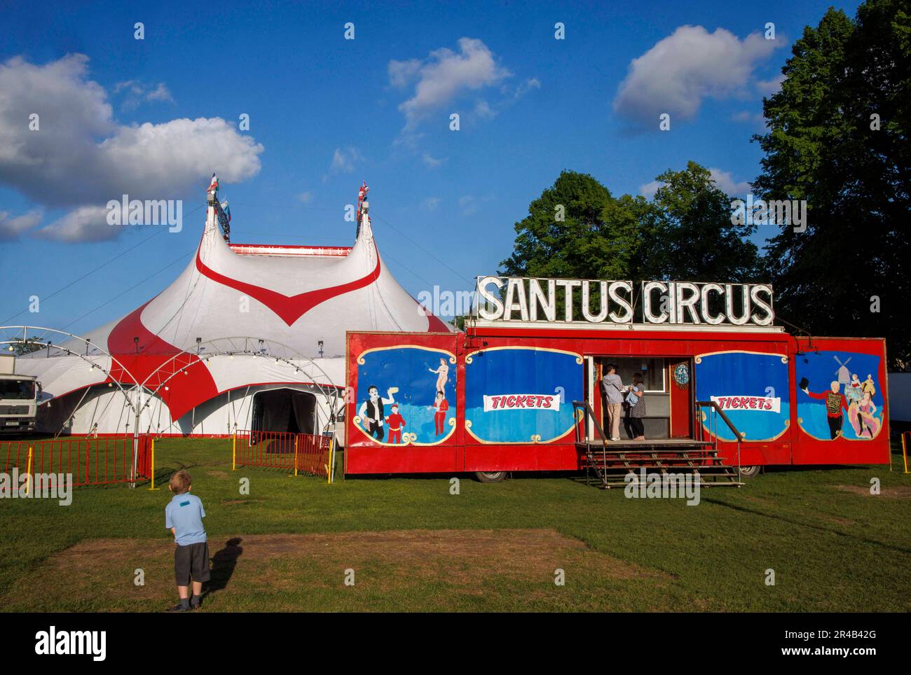 A small boy stands excited outside a Big Circus tent as he waits to ...