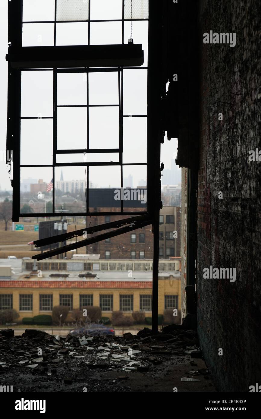 A two-story building with large windows sits behind a broken structure ...