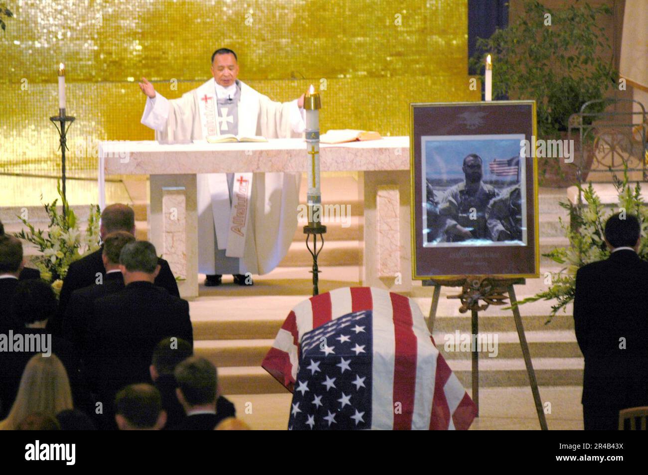 US Navy U.S. Navy Chaplain, Cmdr. delivers an invocation during a ...