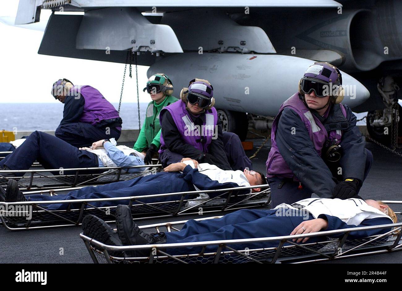 US Navy Crew members aboard the Nimitz-class aircraft carrier USS ...
