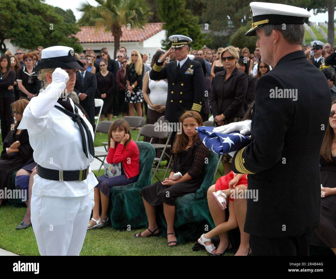 US Navy An Honor Guard member presents the casket flag of Senior Chief ...