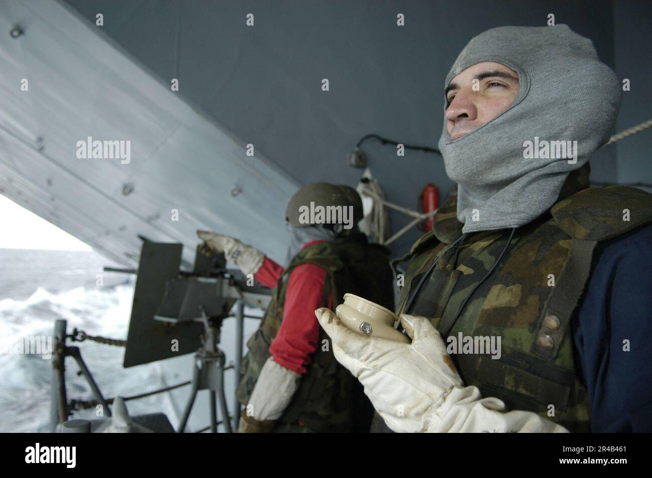 US Navy Aviation Ordnanceman 1st Class monitors the horizon to ensure ...