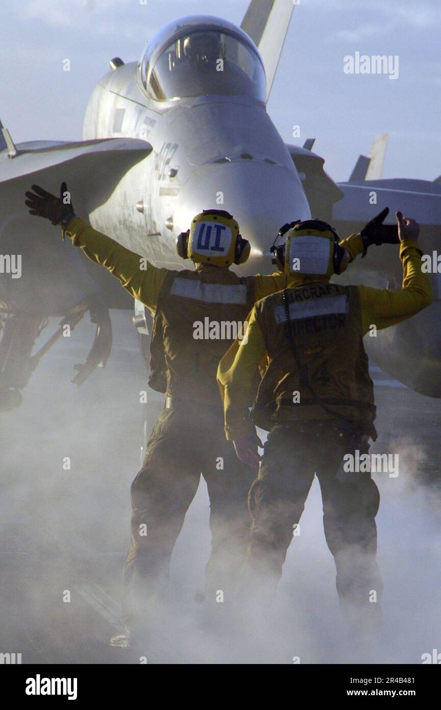 US Navy An aircraft director under instruction, left, taxies an F-A-18C ...