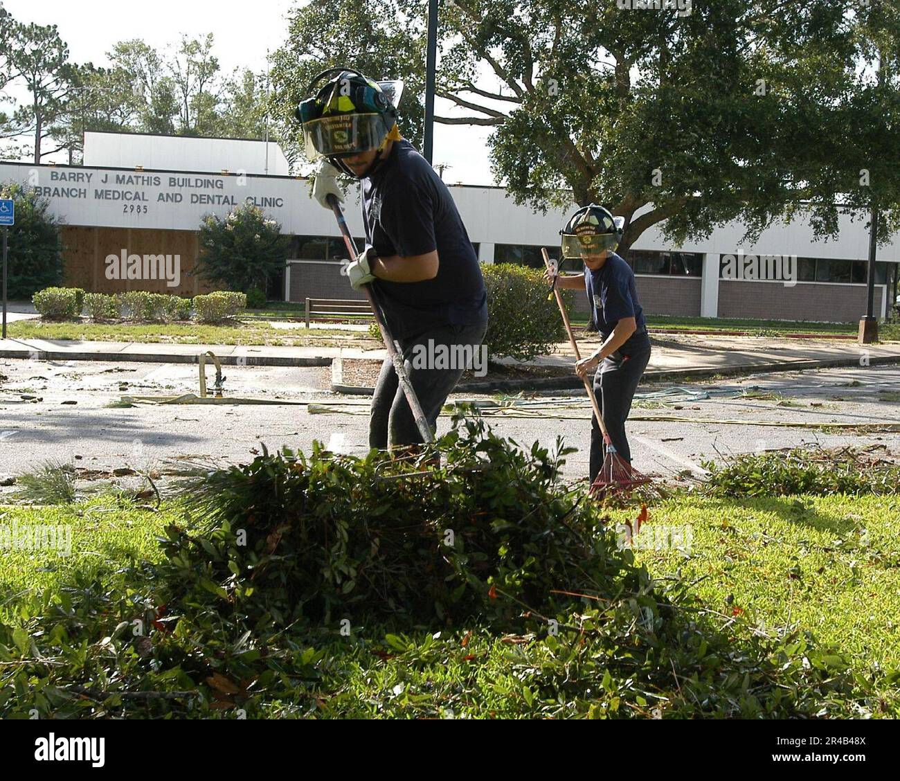 US Navy Federal Firefighters clean up debris left from Hurricane Dennis ...