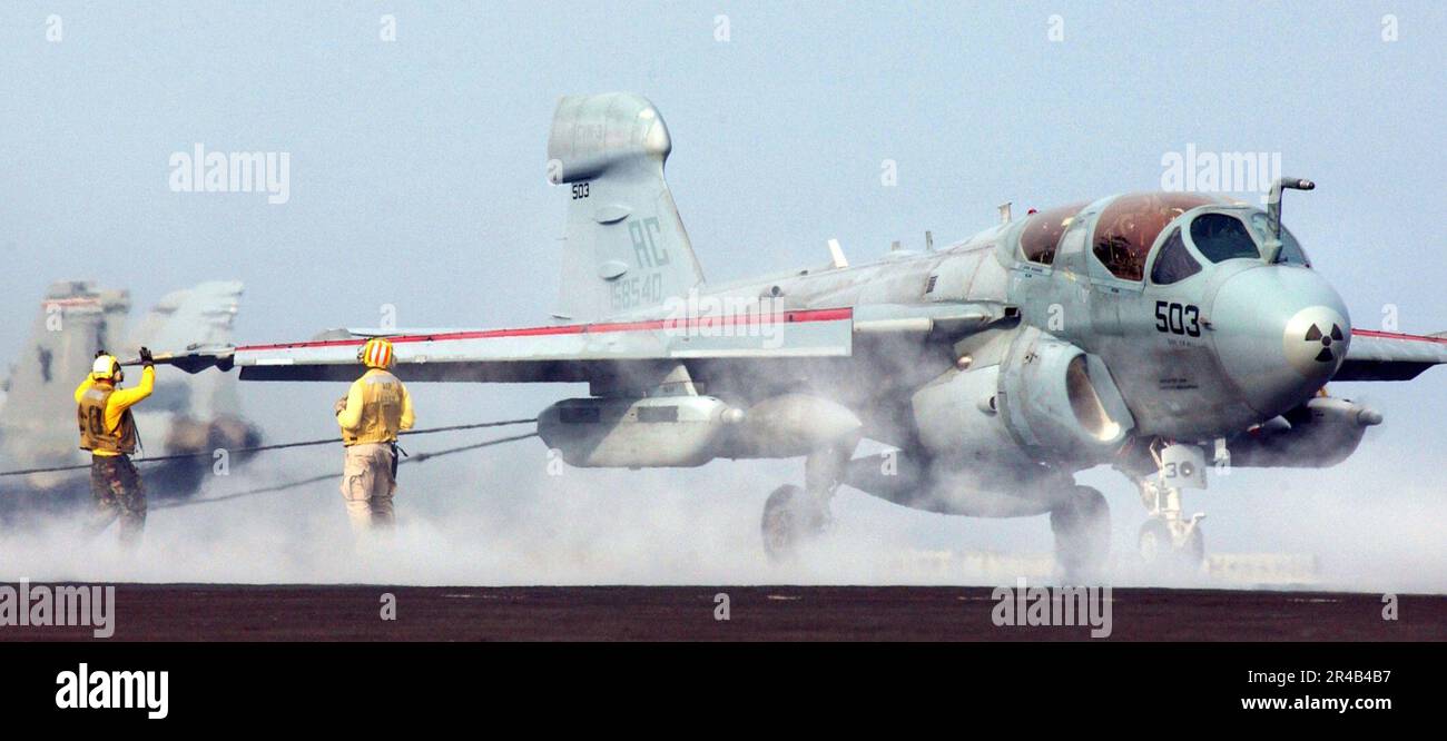 US Navy Aircraft handlers signal to the aircrew of an EA-6B Prowler ...