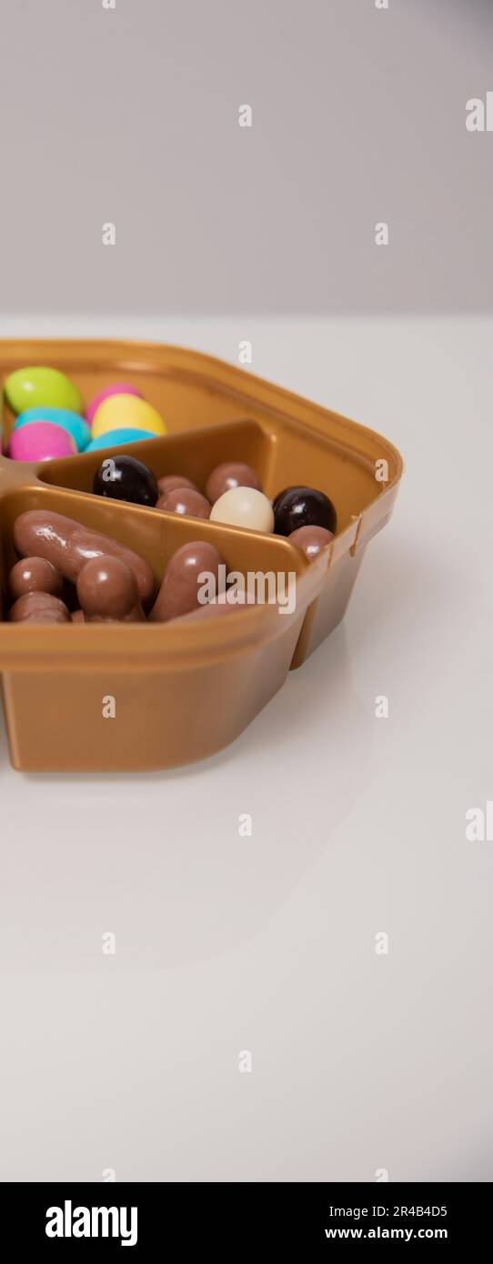 colored chocolate dragees on white surface. close-up Stock Photo - Alamy