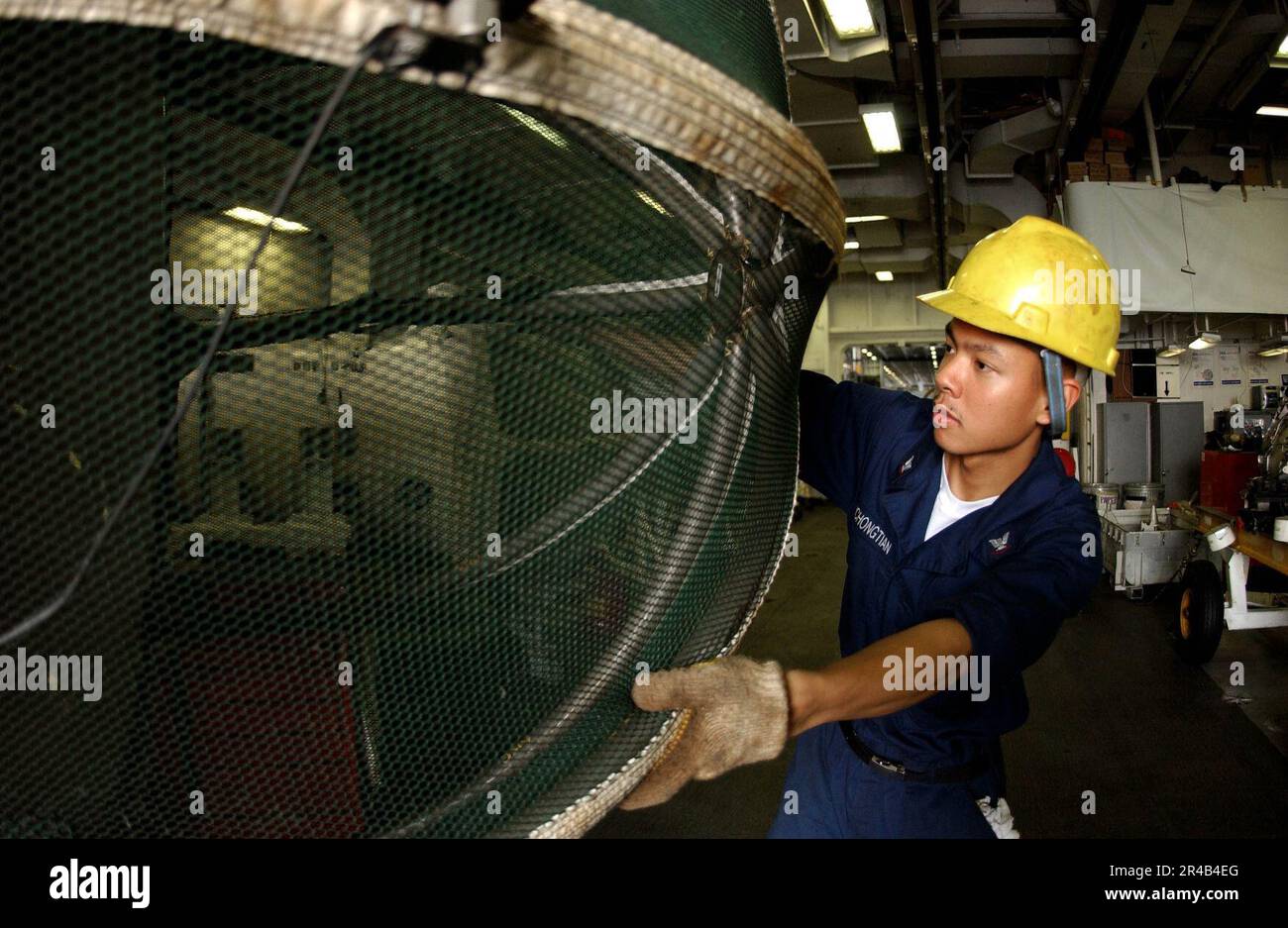 US Navy Aviation Machinist's Mate 3rd Class inspects the cover for an J ...