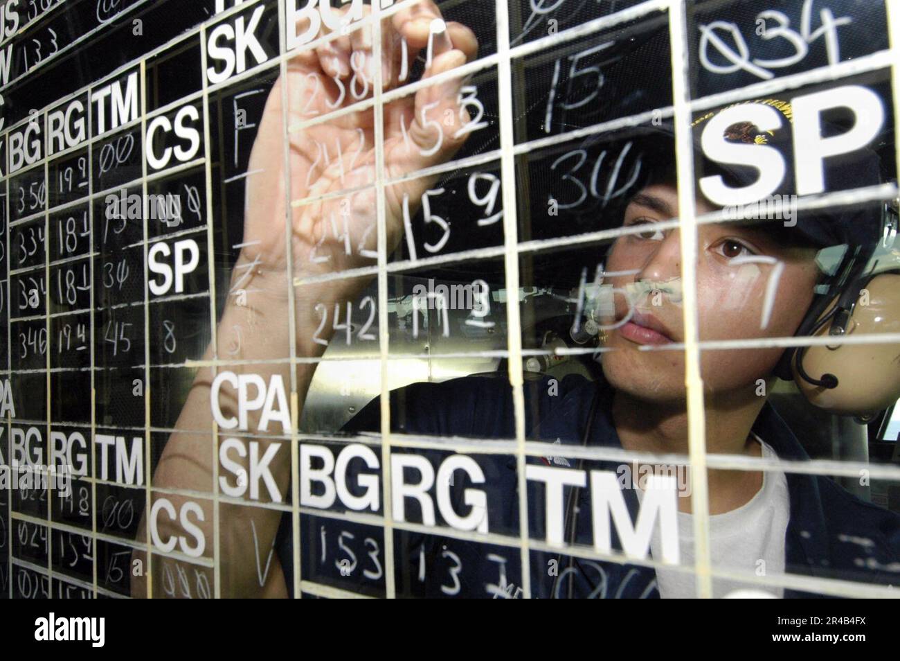 US Navy Operations Specialist 3rd Class updates a status board while ...
