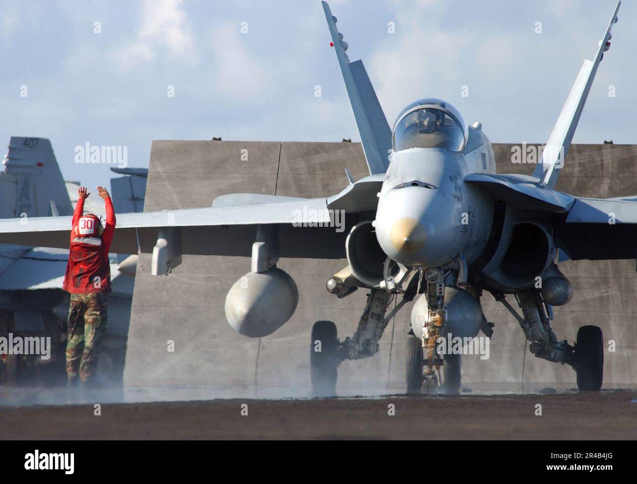 US Navy An Aviation Ordnanceman signals the pilot of an F-A-18A- Hornet ...