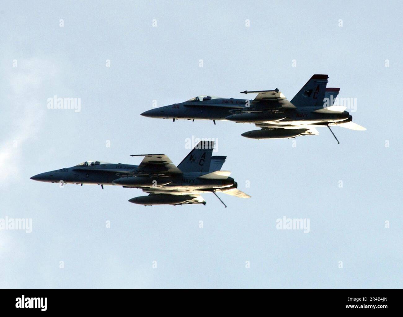 US Navy Two F-A-18C Hornets fly in approach formation over the Nimitz ...