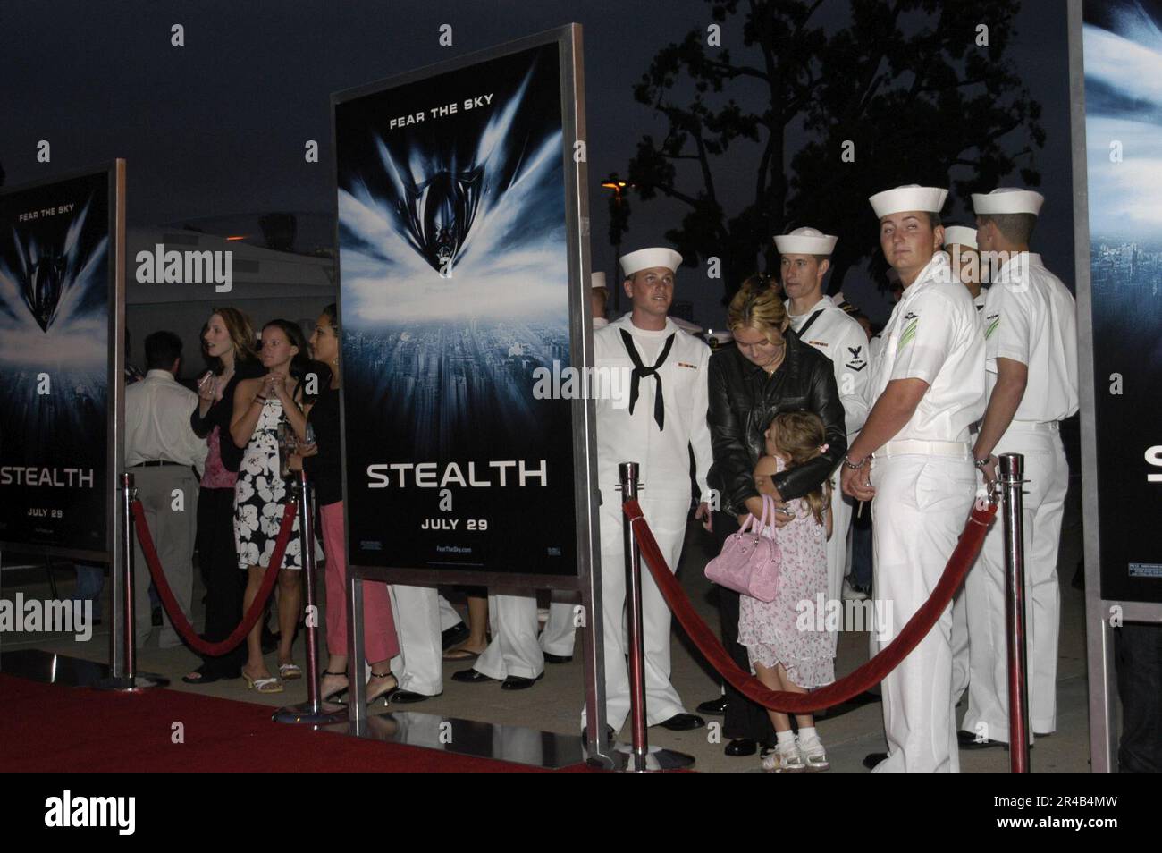 US Navy Sailors and families members wait outside the base theatre on ...