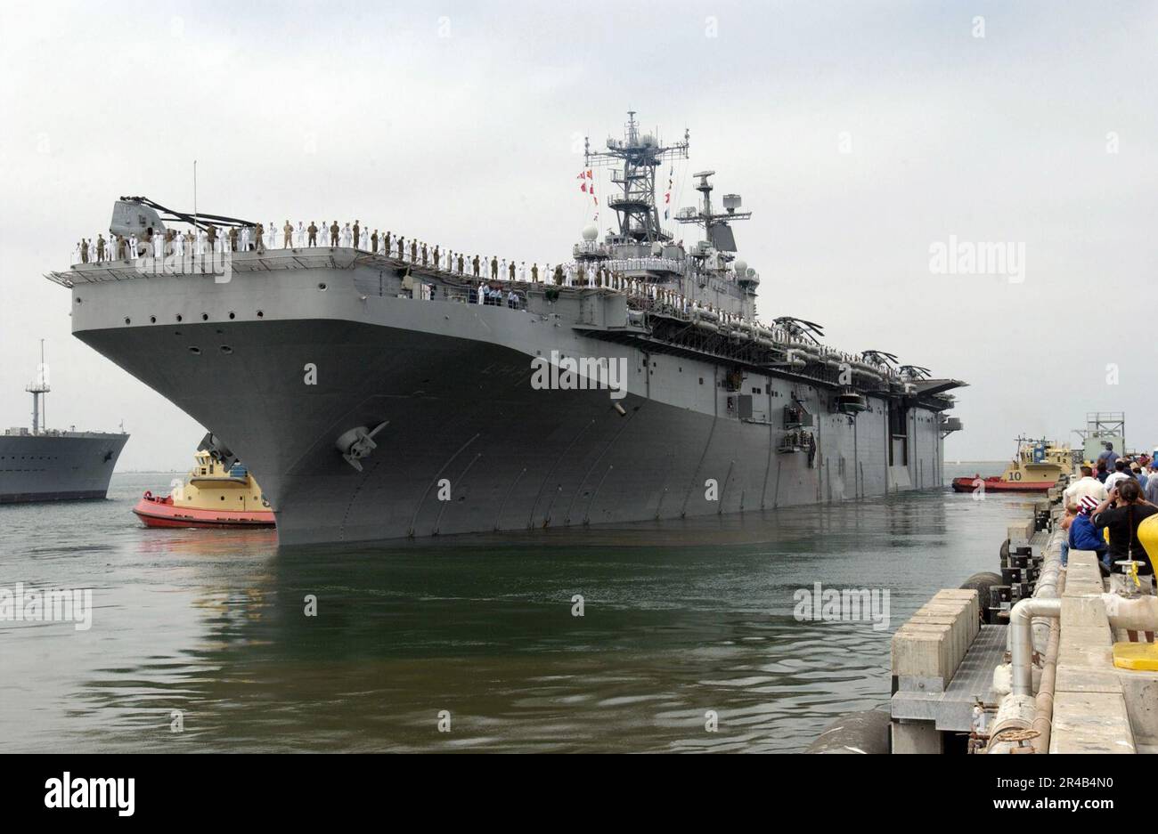 US Navy Sailors and Marines aboard the amphibious assault ship USS ...