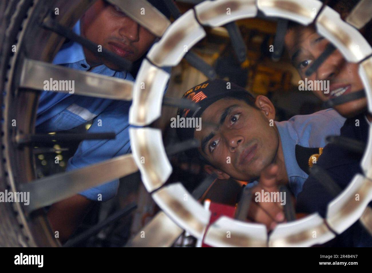 US Navy Sub Lt. peers into an F-A-18F Super Hornet jet engine in the ...