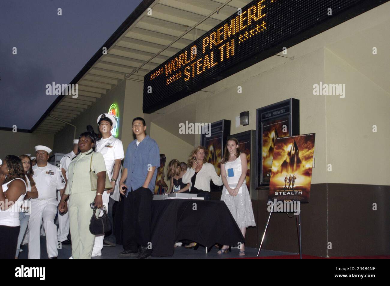 US Navy Sailors and families members wait outside the base theatre on ...