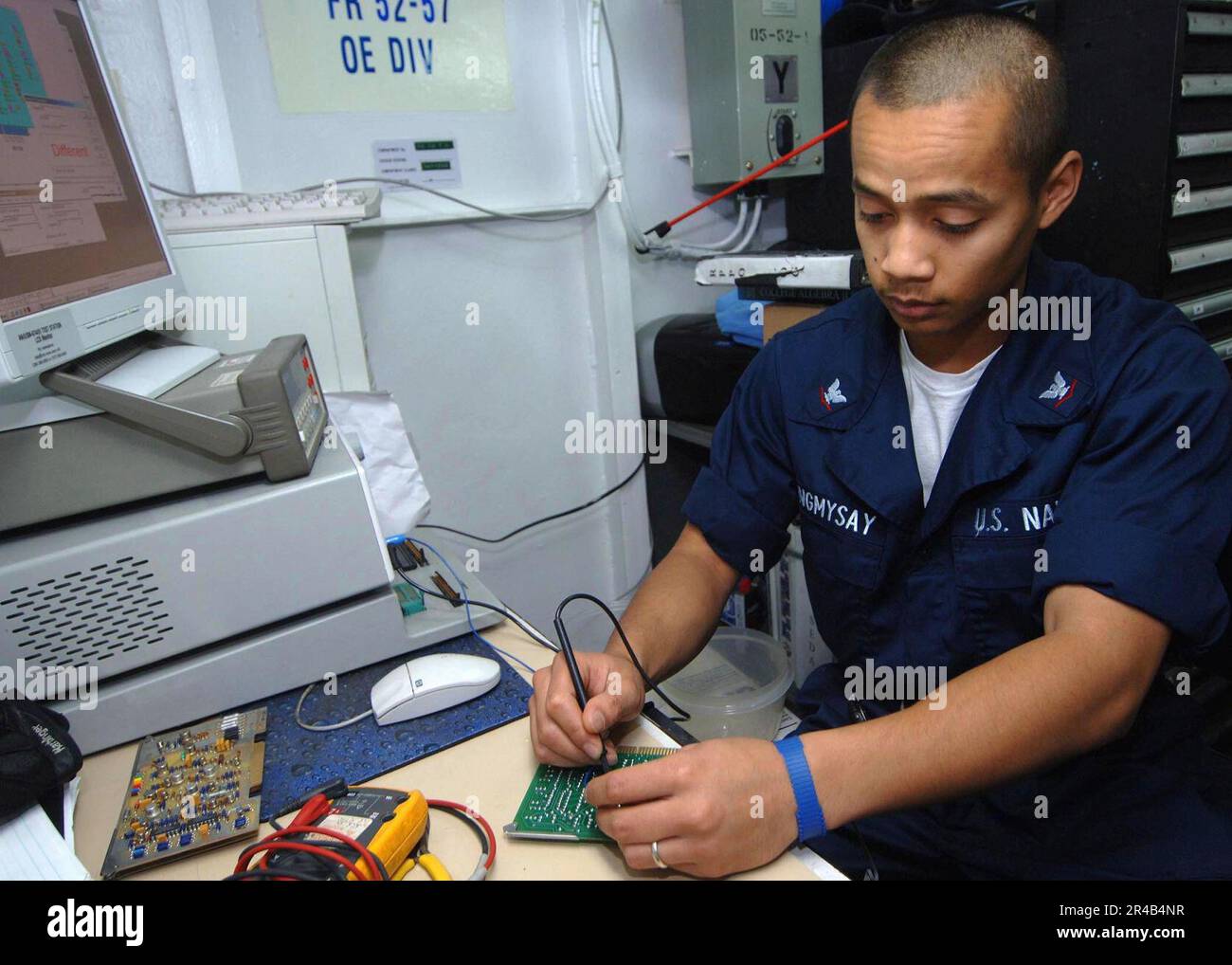 US Navy Electronics Technician 3rd Class troubleshoots a malfunctioning ...