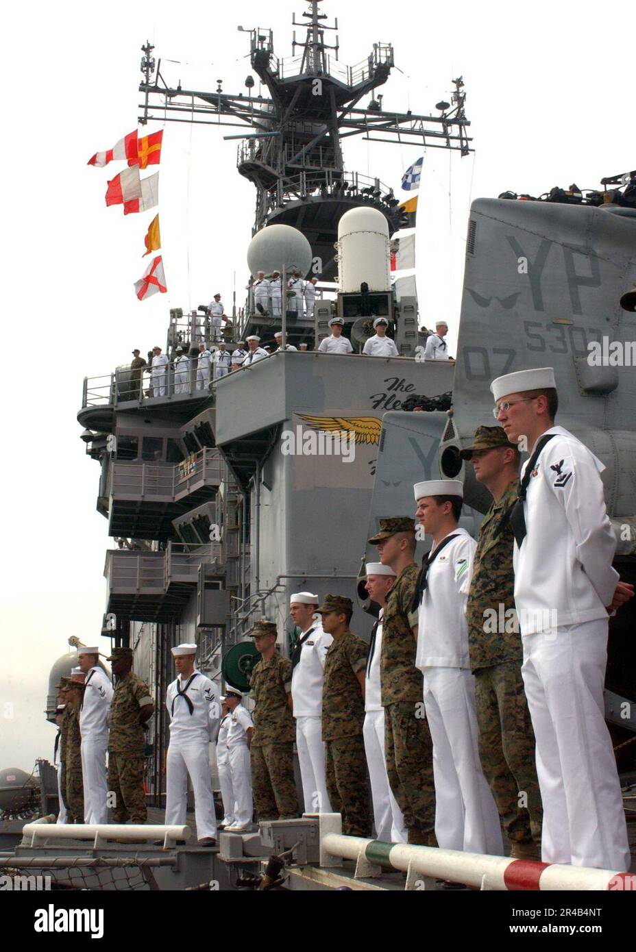 US Navy Sailors and Marines man the rails as they leave port for a ...