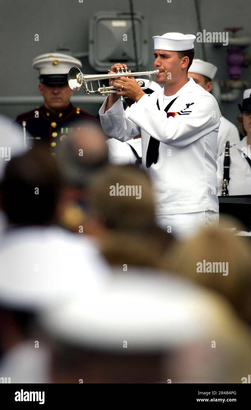 US Navy A lone bugler plays taps during a memorial service for retired ...