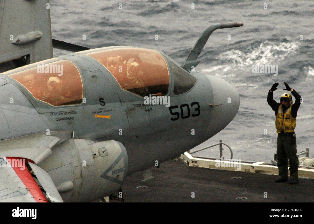 US Navy An aircraft handler directs an EA-6B Prowler on the flight deck ...
