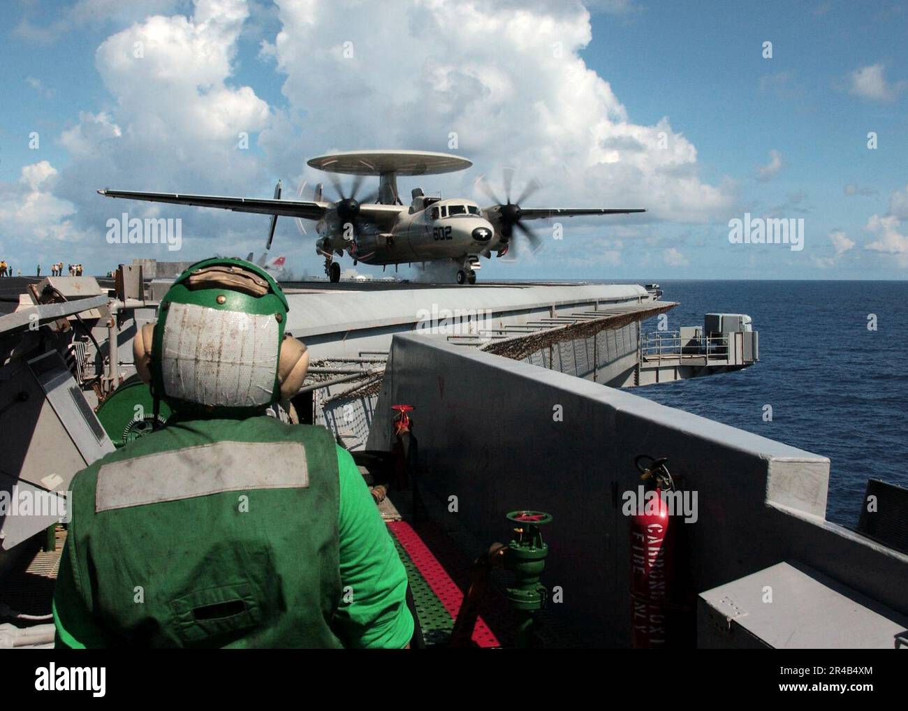 US Navy A Sailor observes an E-2C Hawkeye as it launches from the ...