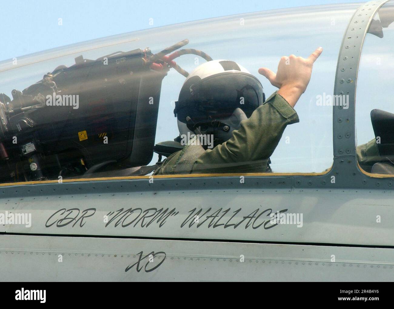 US Navy A Radar Intercept Officer (RIO) gives a hang loose sign to the crowd of Air Department ...
