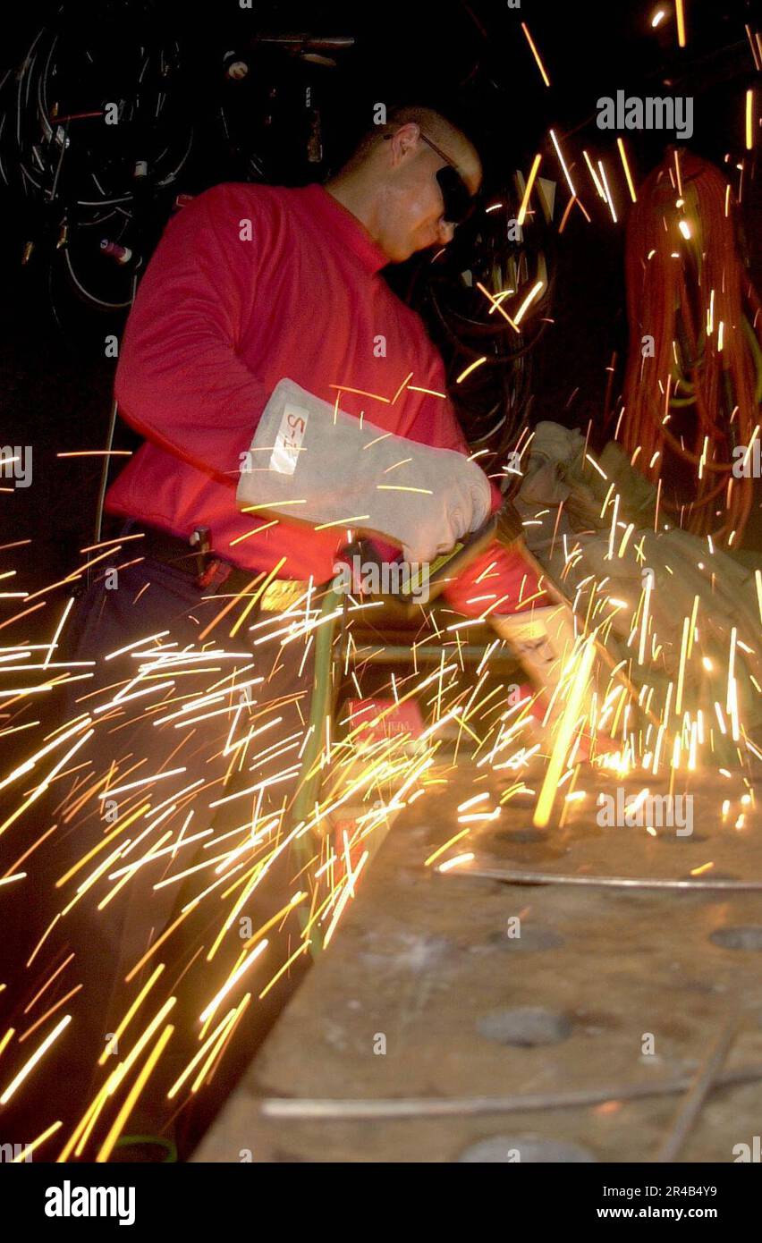 US Navy Damage Controlman 2nd Class uses a Portable Exothermic Cutting ...