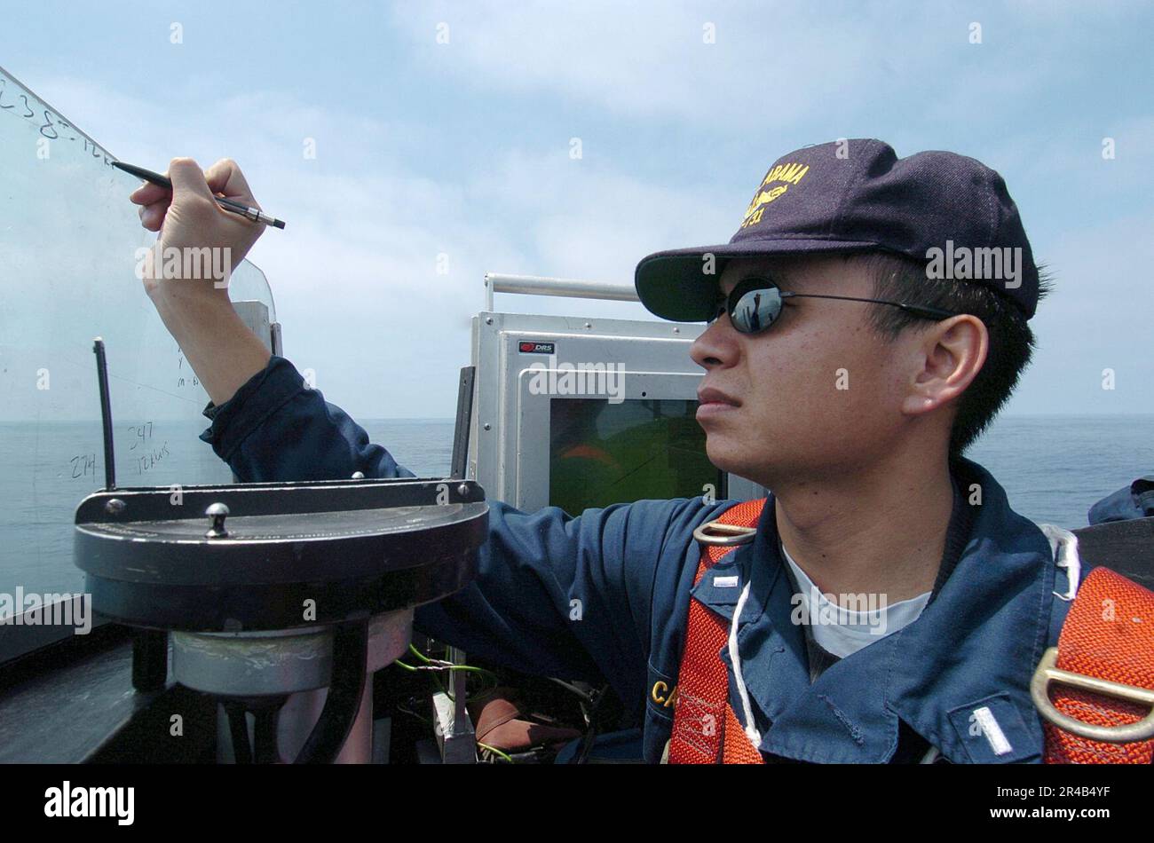 US Navy Officer of the Deck Lt.j.g. logs the current heading of the ...