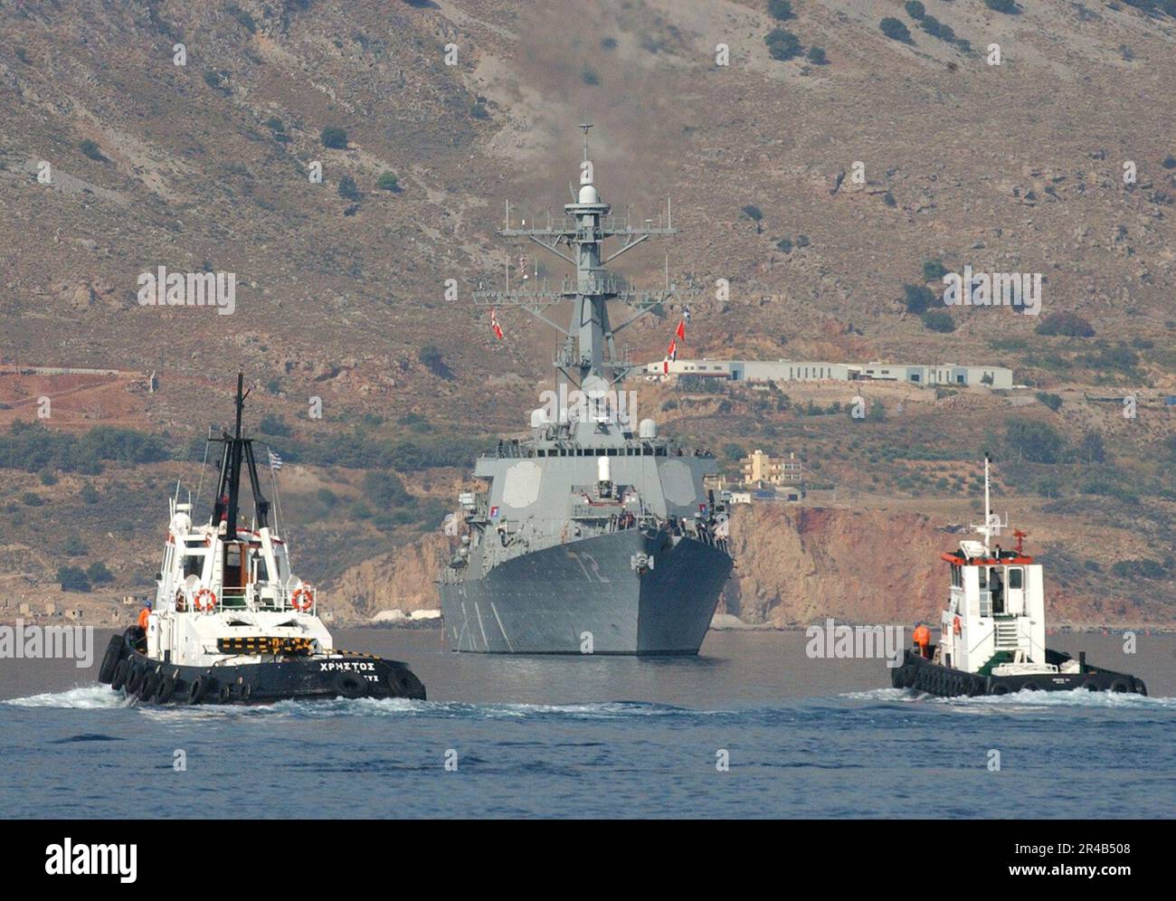 US Navy Tug boats head out to meet the guided missile destroyer USS ...