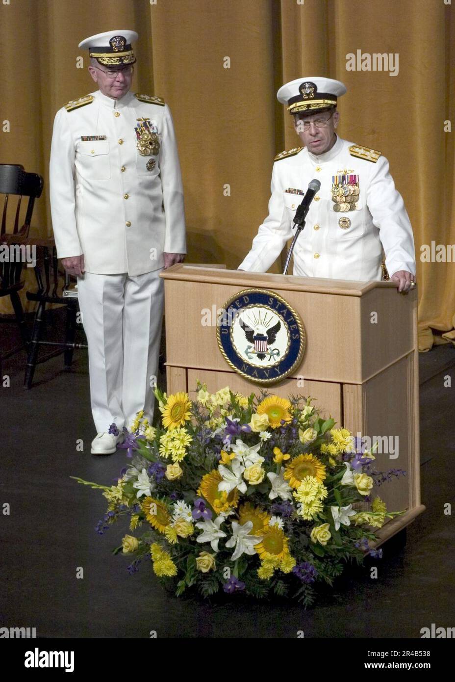 US Navy Adm. Mike Mullen reads his official orders as Adm. Vern Clark ...