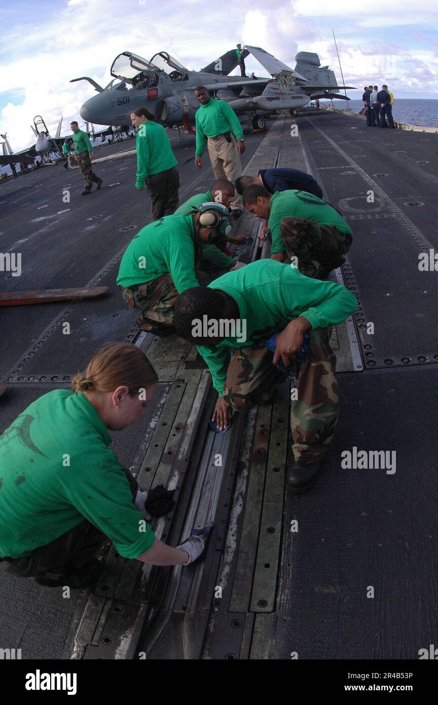 US Navy Sailors assigned to the Air Department reinstall a nose gear ...