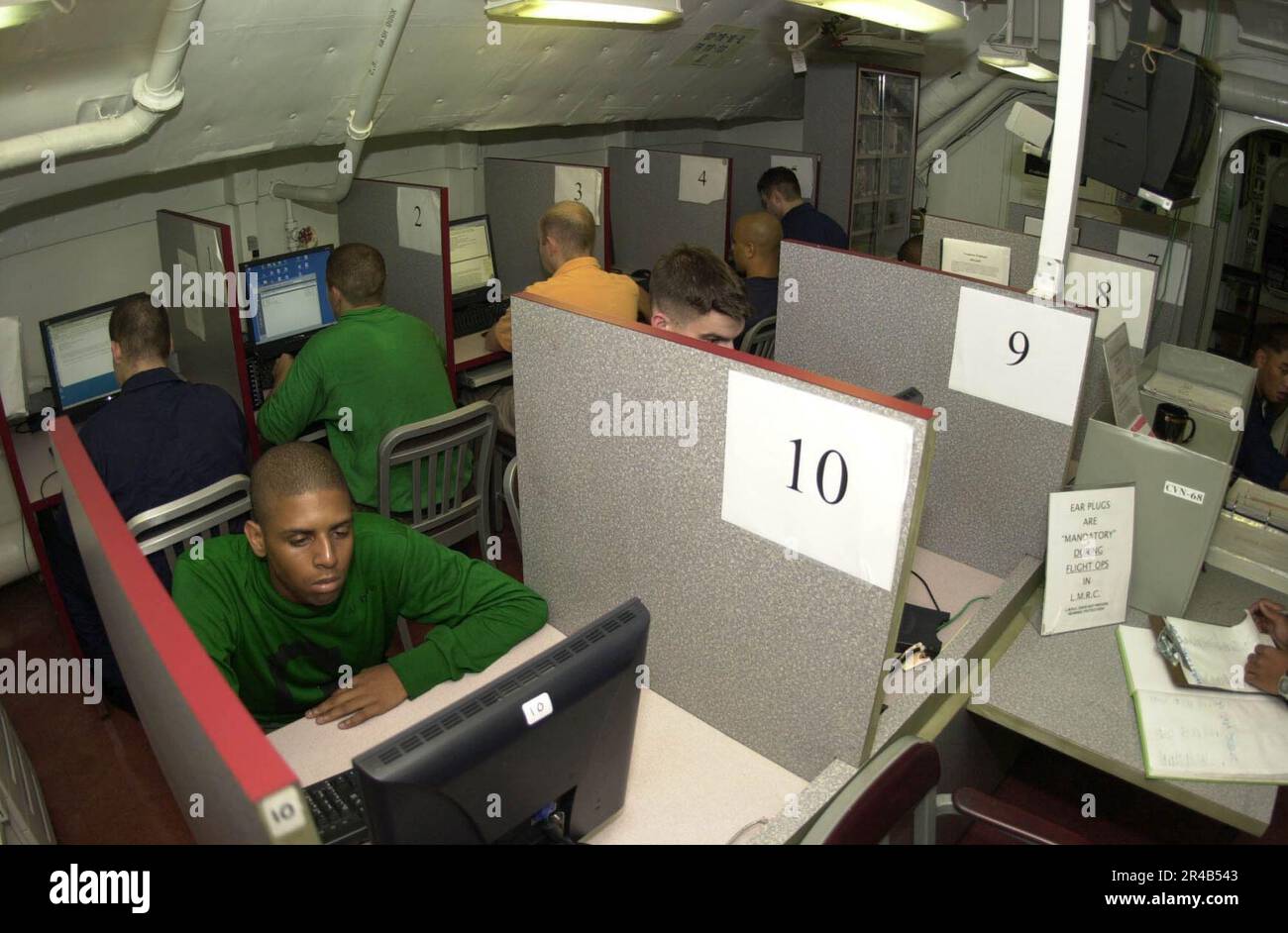 US Navy Sailors check their e-mail in the ship's library during their ...